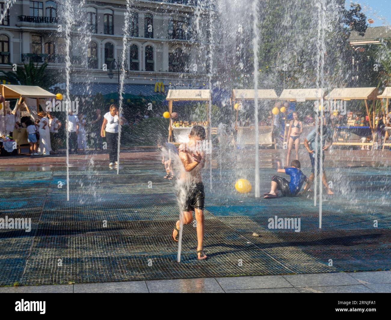 Batumi, Georgia. 08.19.2023 Children play in the fountain. Children's ...