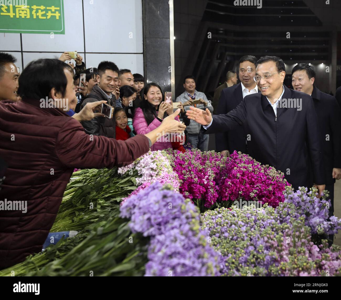 Chinese Premier Li Keqiang (R, front) inspects a flower market in ...