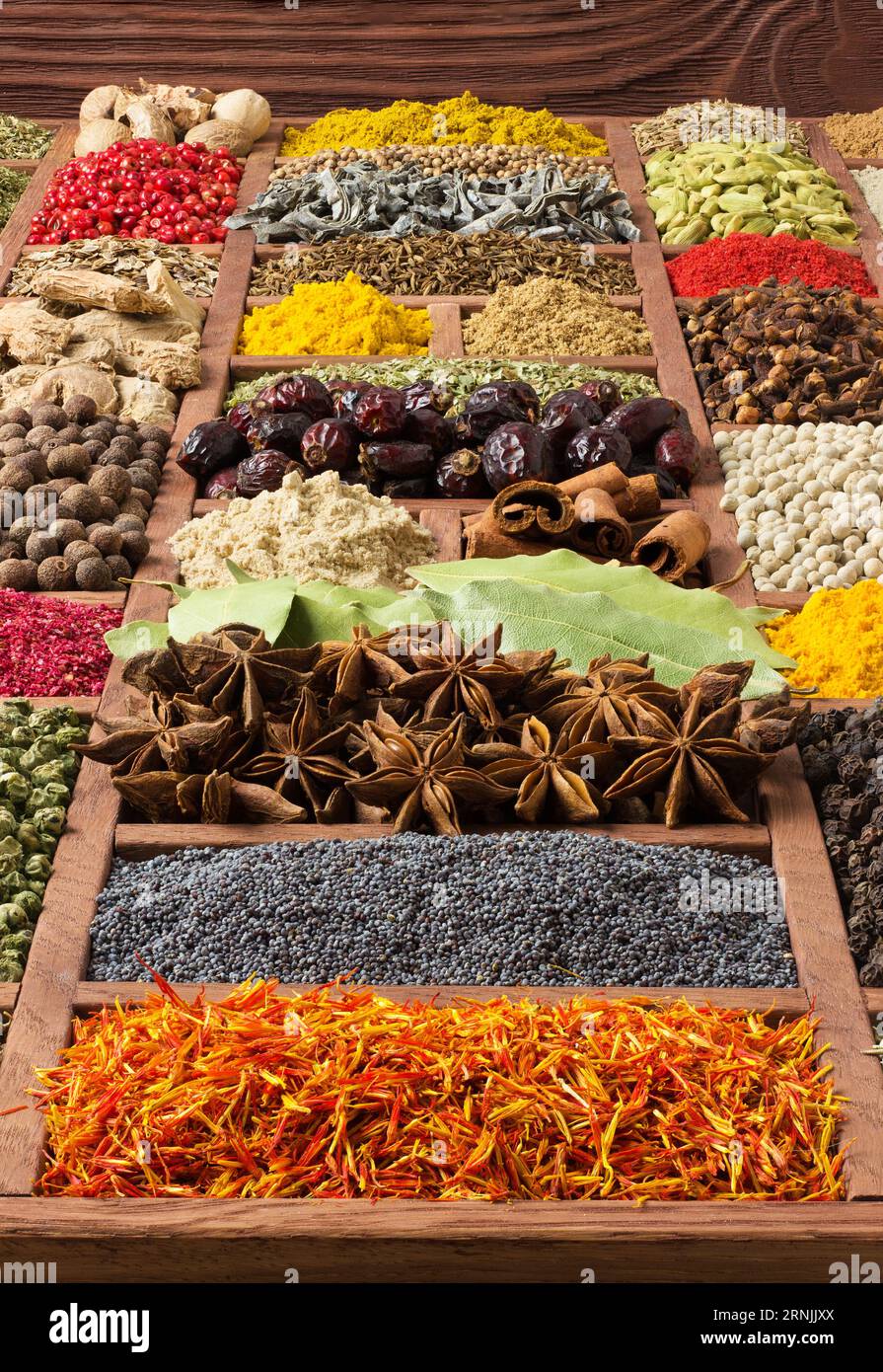 spices and herbs collection in wooden tray. Colorful condiments as ...