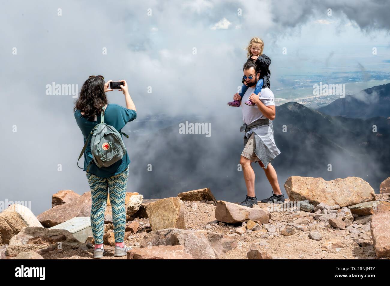 Pikes Peak Colorado Springs - tourists at summit take in view of clouds ...