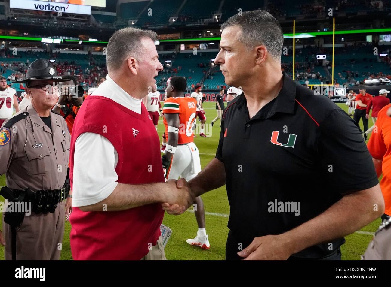 Miami (Ohio) head coach Chuck Martin, left, and Miami head coach Mario ...