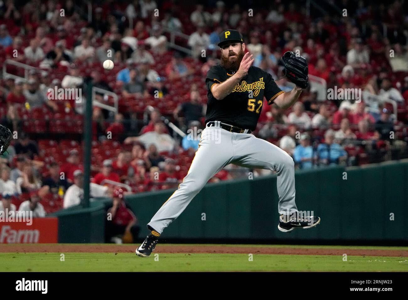 Pittsburgh Pirates relief pitcher Colin Selby commits an error trying ...