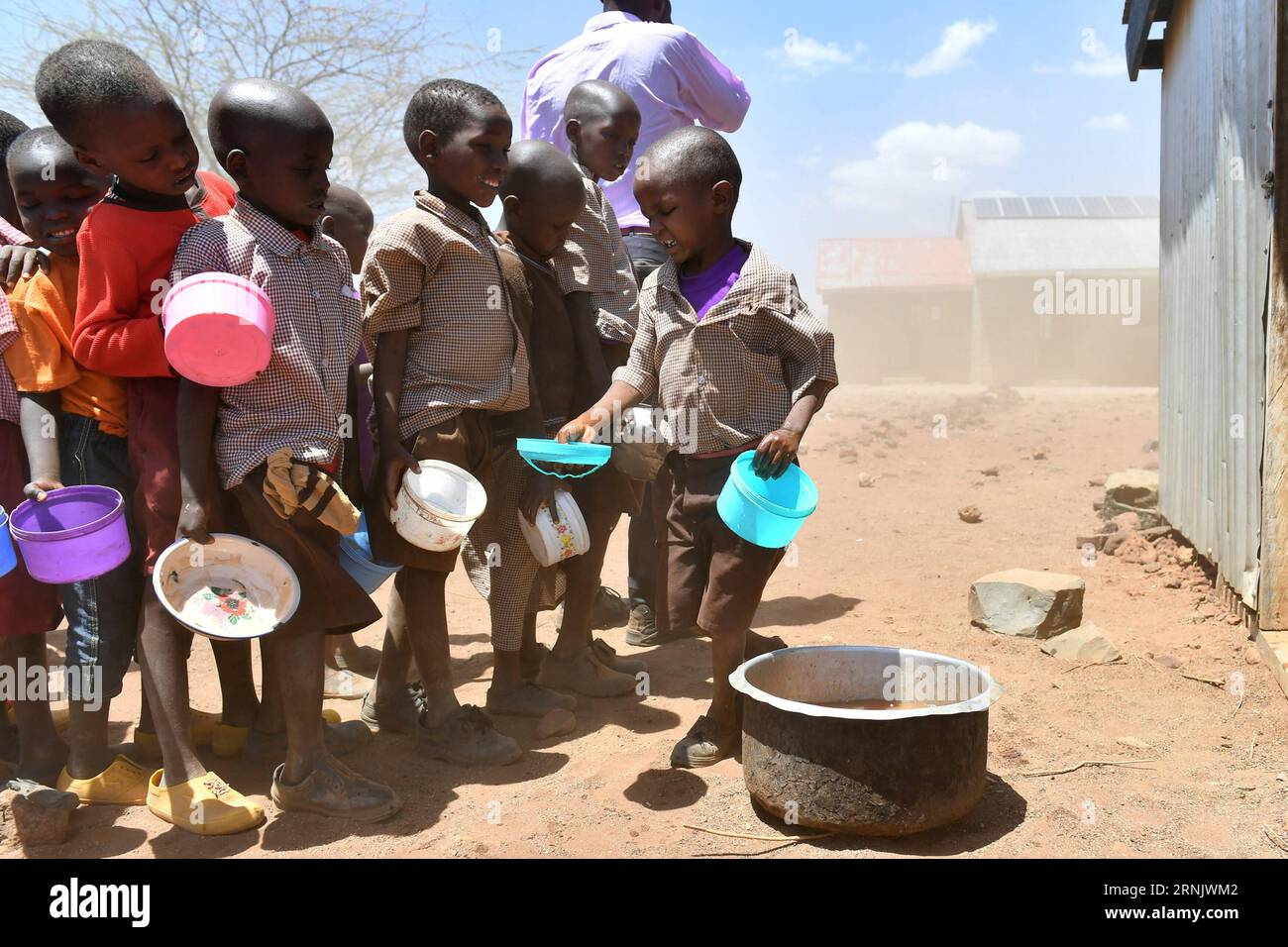 KAJIADO (KENYA), Students wash the dishes after lunch at Olomayiana ...