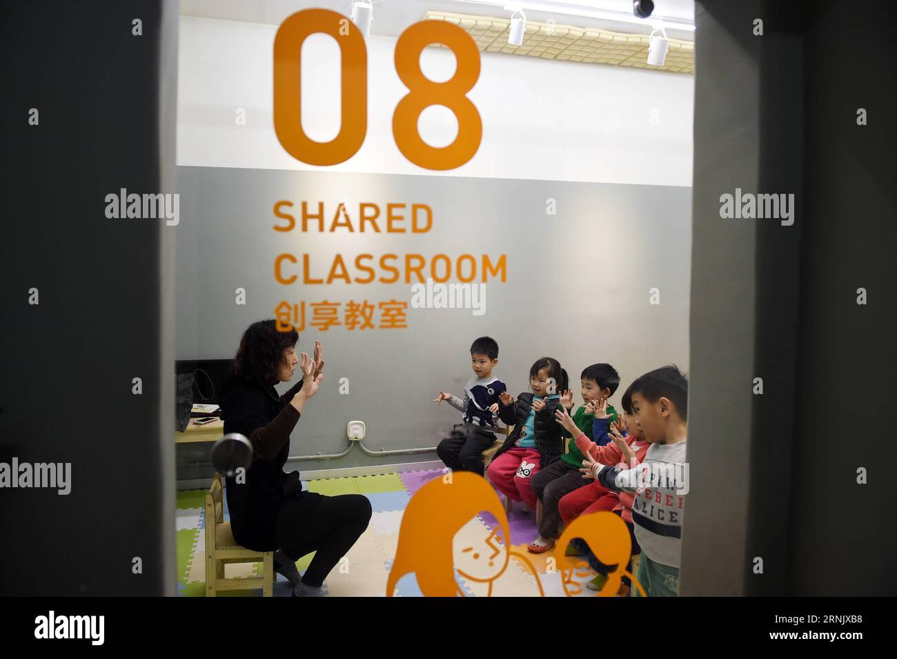 A resident interacts with children at a shared classroom of the ...