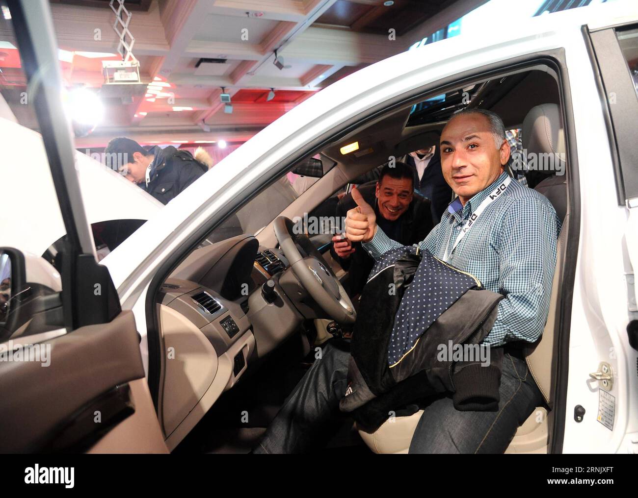 A visitor tries the new DFM S50 sedan in an event in Damascus, capital ...