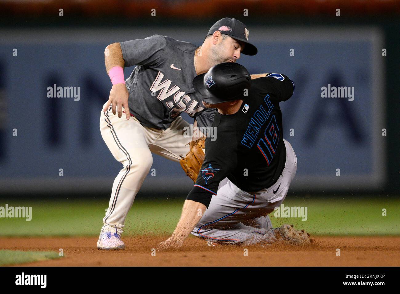 Miami Marlins' Joey Wendle (18) steals second against Washington ...