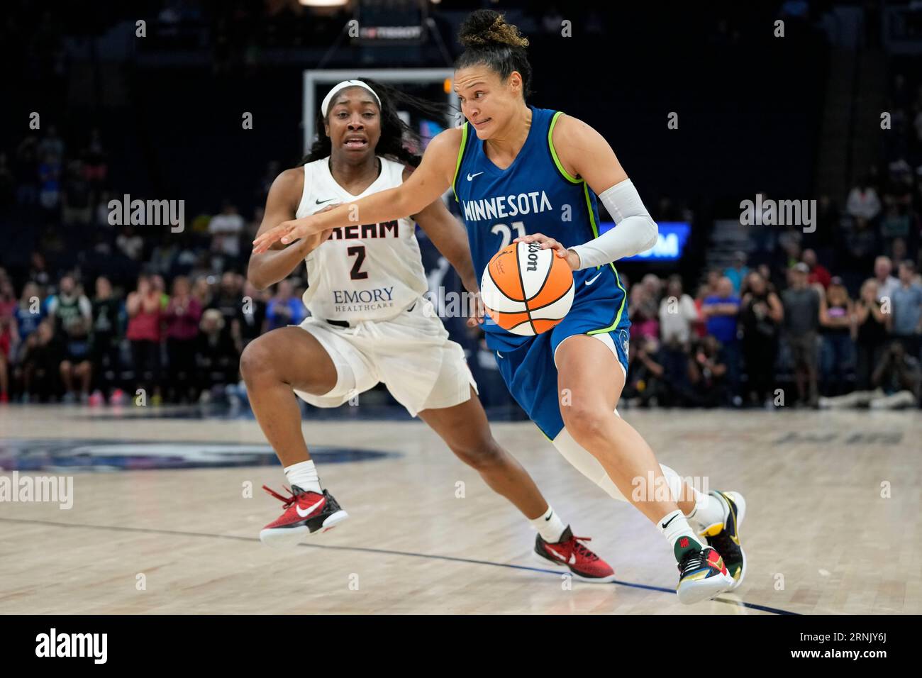 Minnesota Lynx guard Kayla McBride, right, works toward the basket ...
