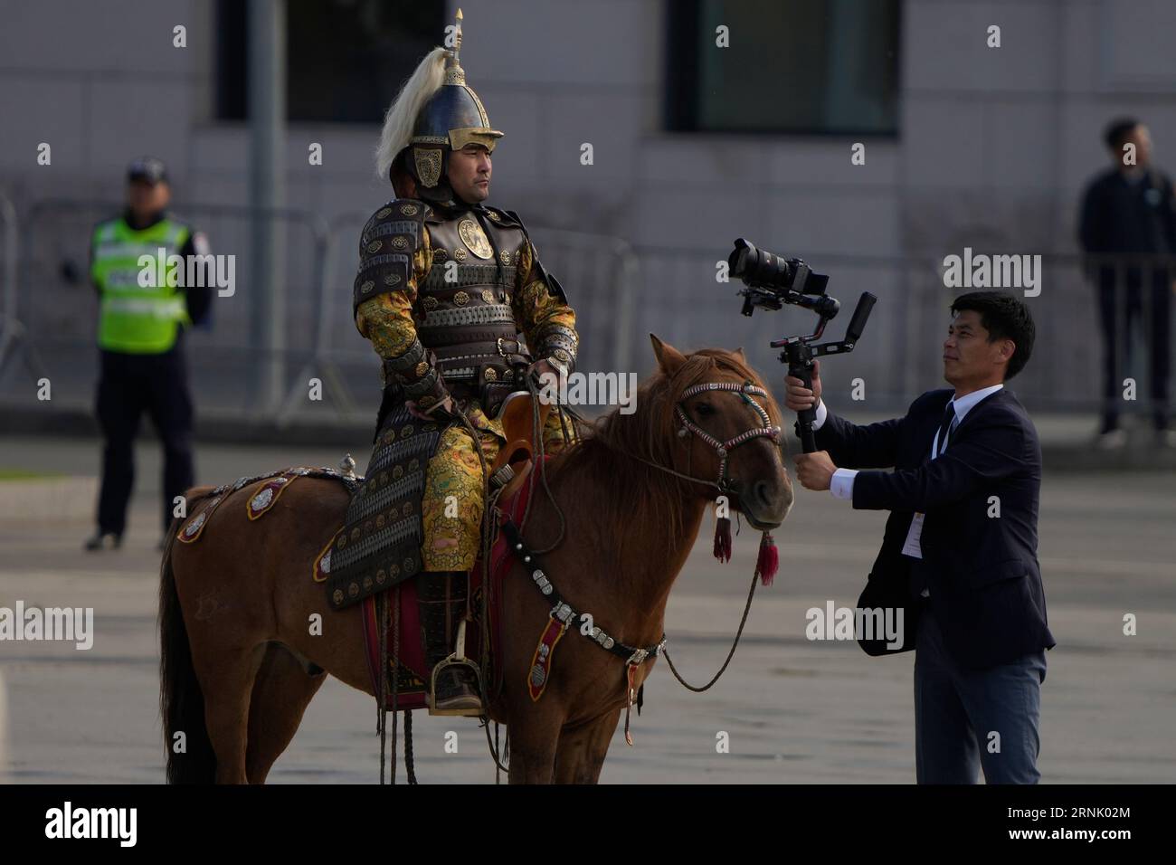 A cameraman films a mounted Mongolian guard patrolling ahead of the ...