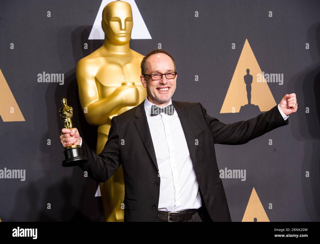 Editor John Gilbert poses after winning the Best Film Editing award for ...