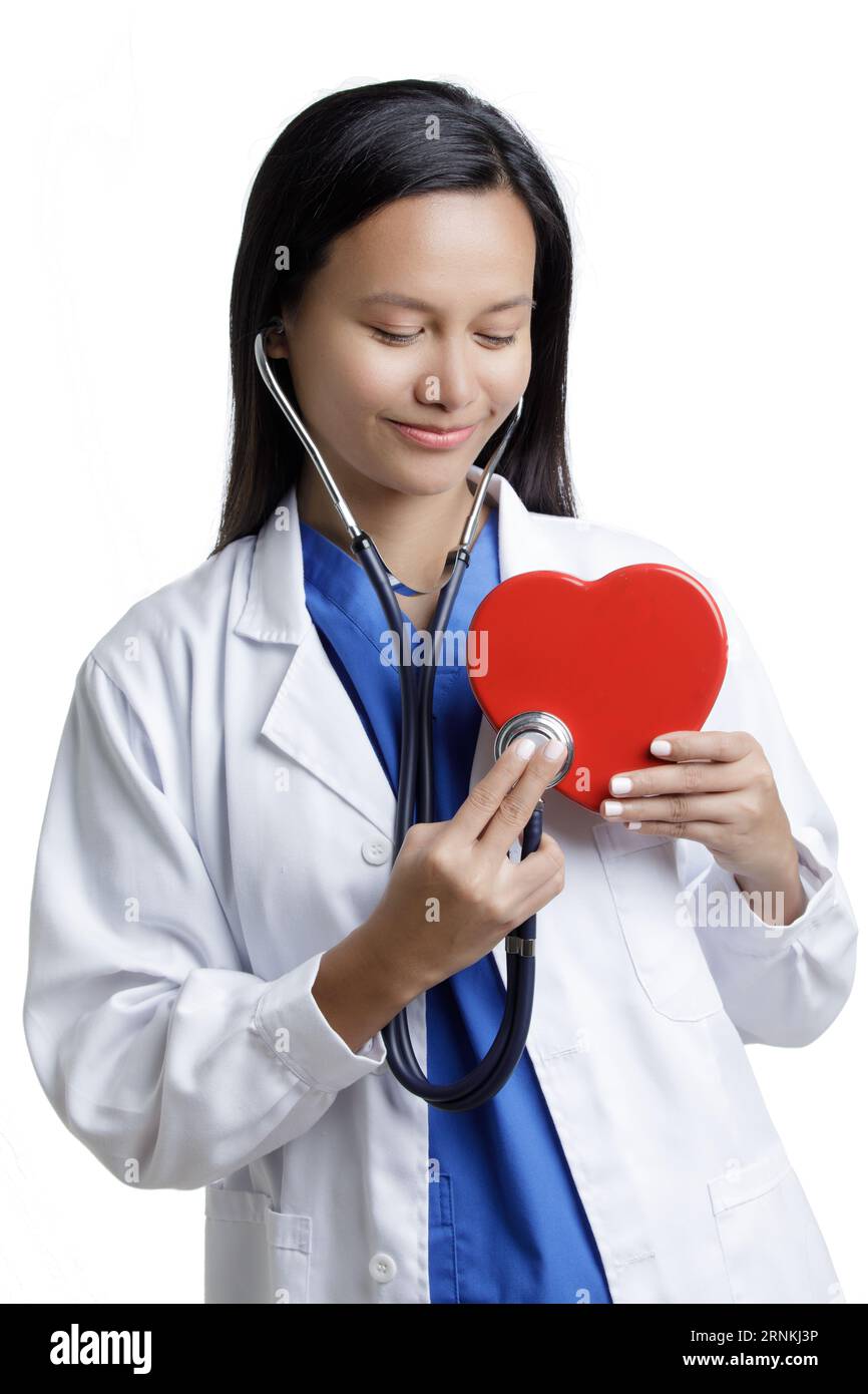 Asian American Woman Doctor examining a Red Heart concept 0f Love of ...
