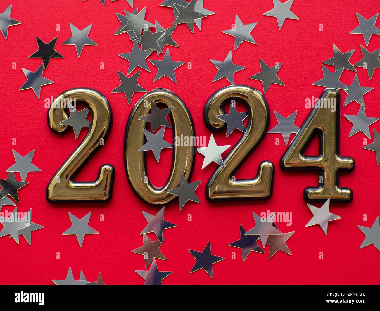 2024 on red background with silver stars Stock Photo - Alamy