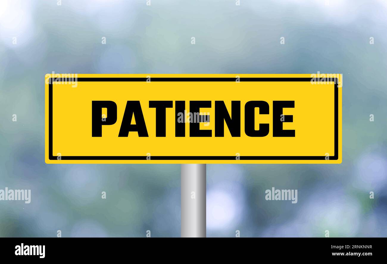 Patience road sign on blur background Stock Photo - Alamy
