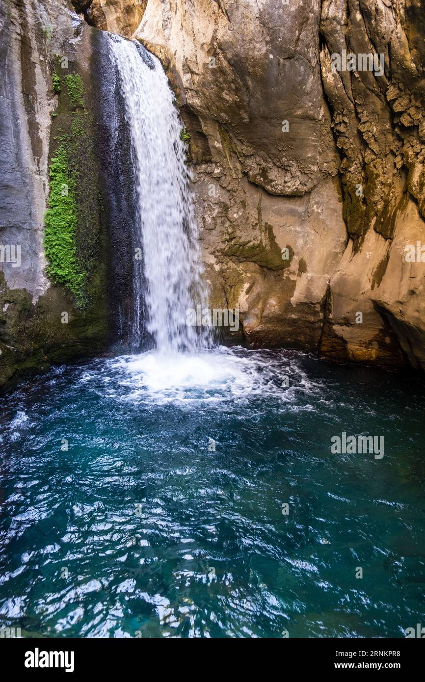A beautiful mountain gorge with a river and a waterfall Stock Photo - Alamy