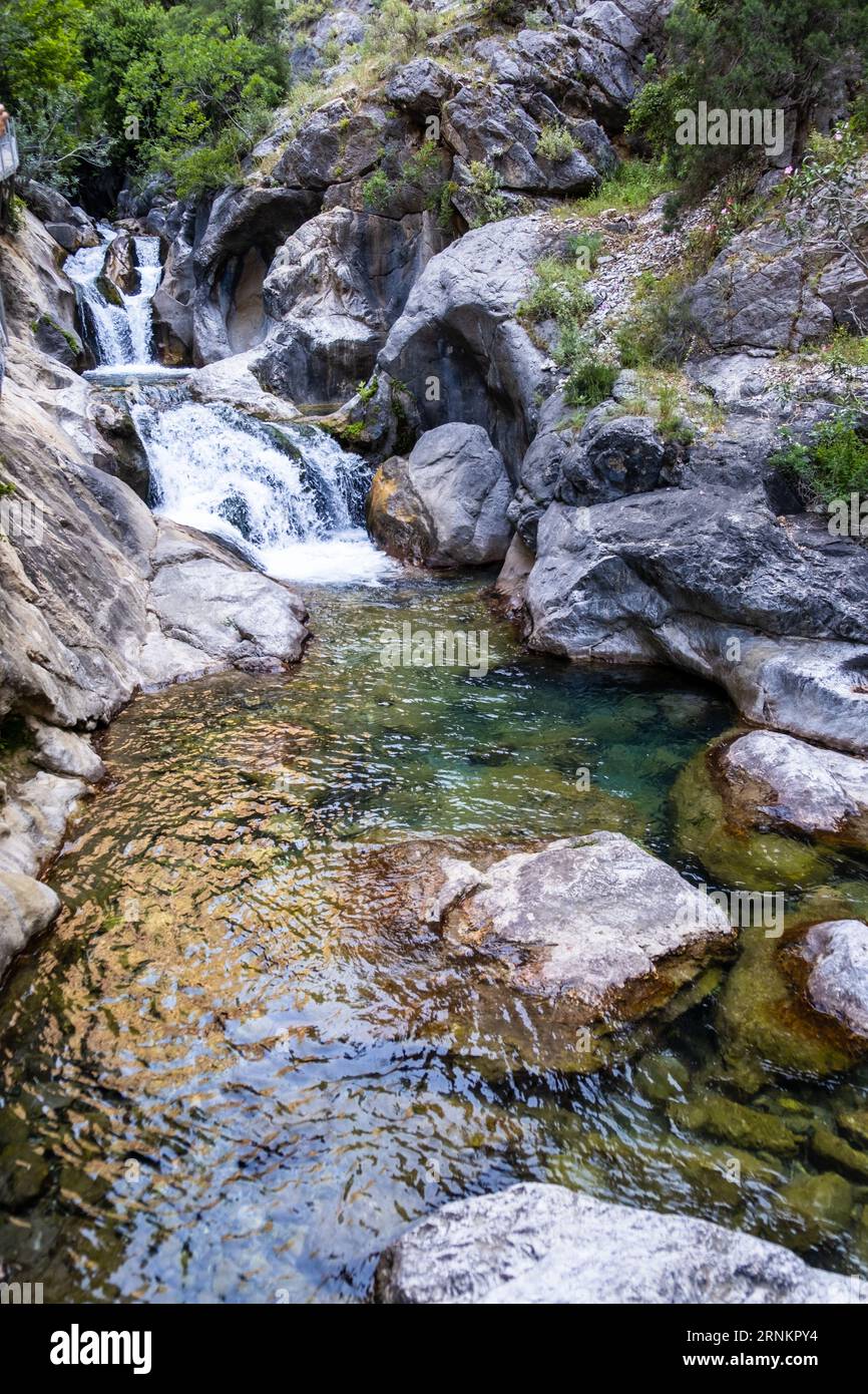 A beautiful mountain gorge with a river and a waterfall Stock Photo - Alamy