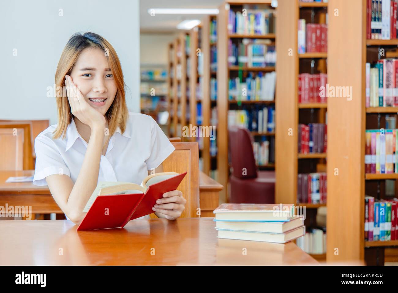 Asian university teen student portrait happy smile in campus library ...