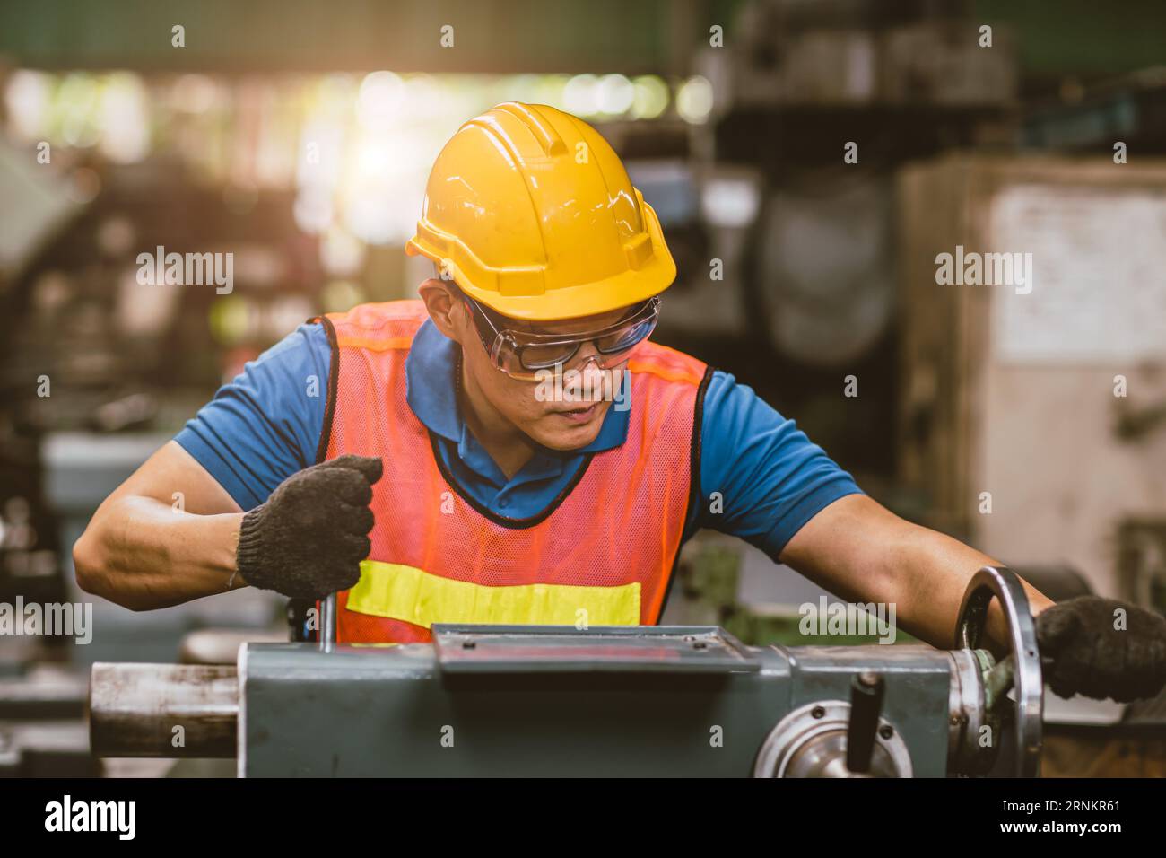 Young Asian Technician Engineer Staff Worker using Lathe CNC Milling ...