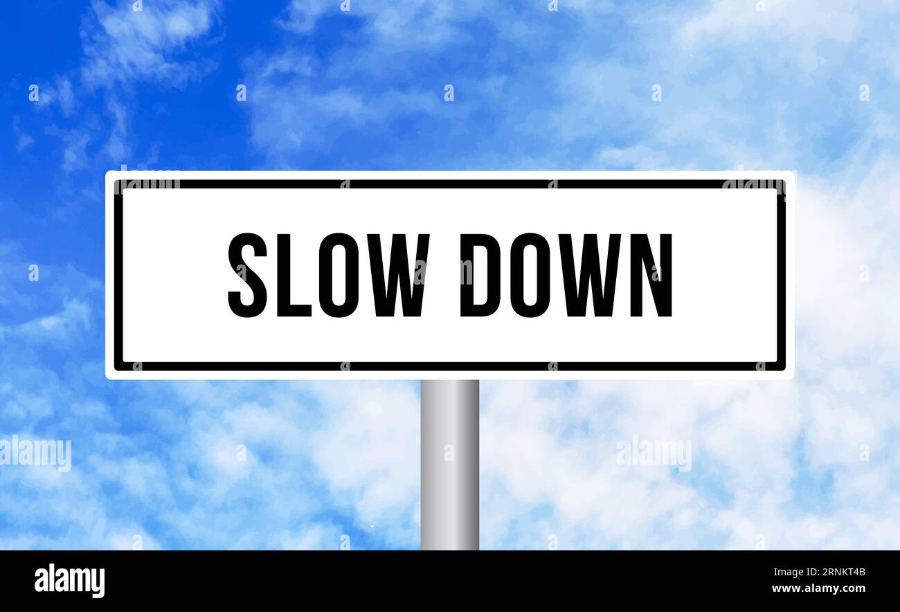 Slow down road sign on cloudy sky background Stock Photo - Alamy