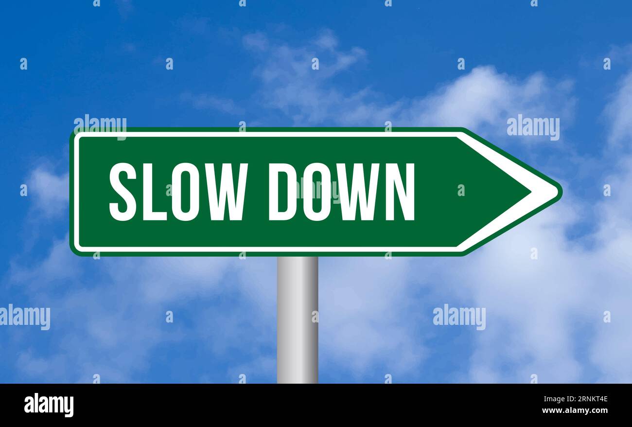Slow down road sign on cloudy sky background Stock Photo - Alamy