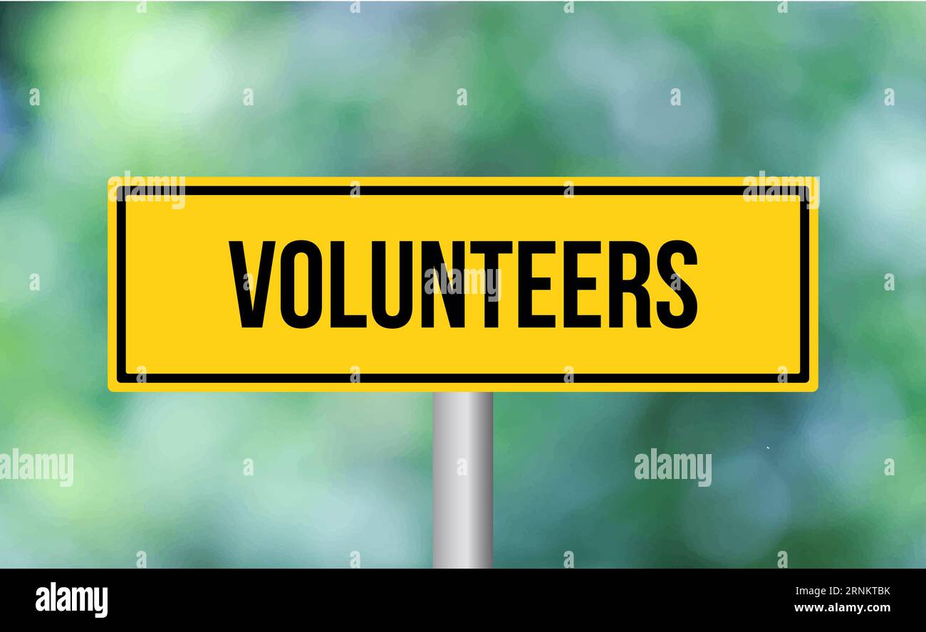 Volunteers road sign on blur background Stock Photo - Alamy