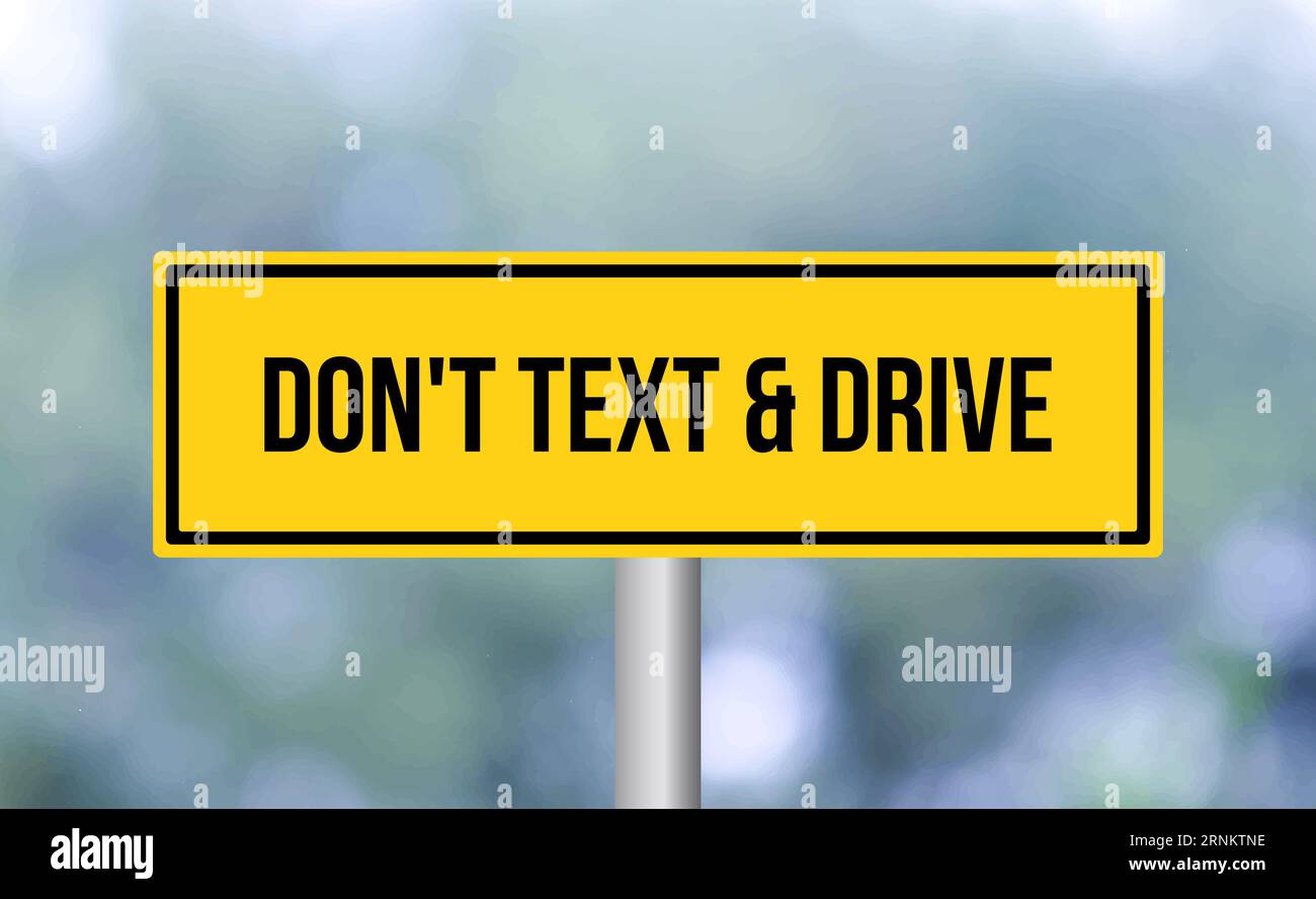 Dont text and drive road sign on blur background Stock Photo - Alamy
