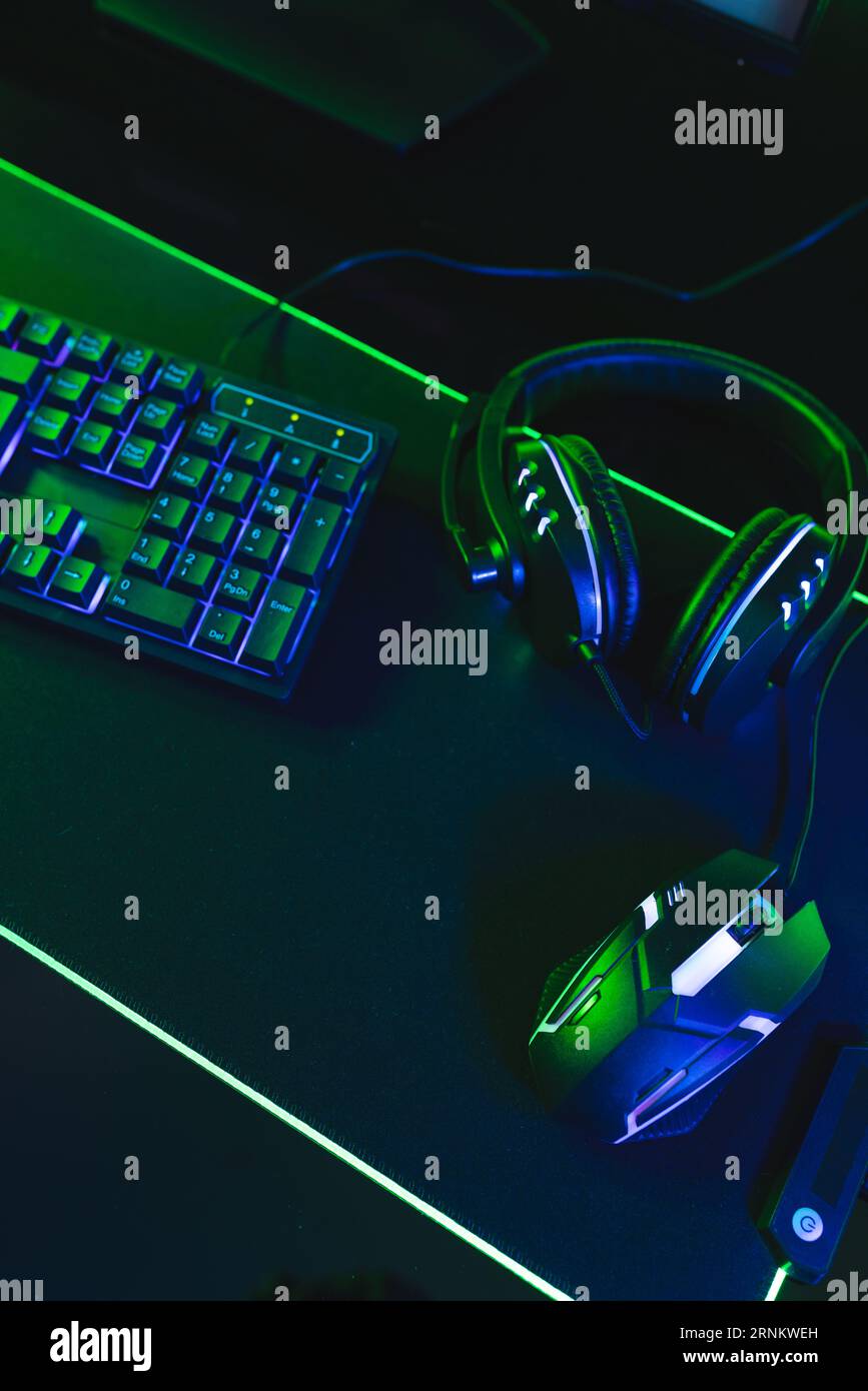 Vertical image of computer, keyboard with video game accessories with ...