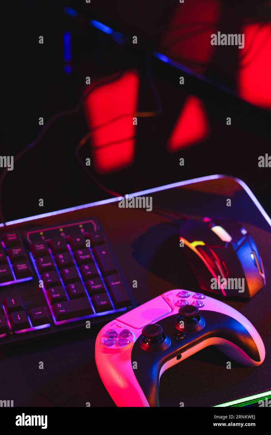 Vertical image of computer keyboard with video game accessories with ...