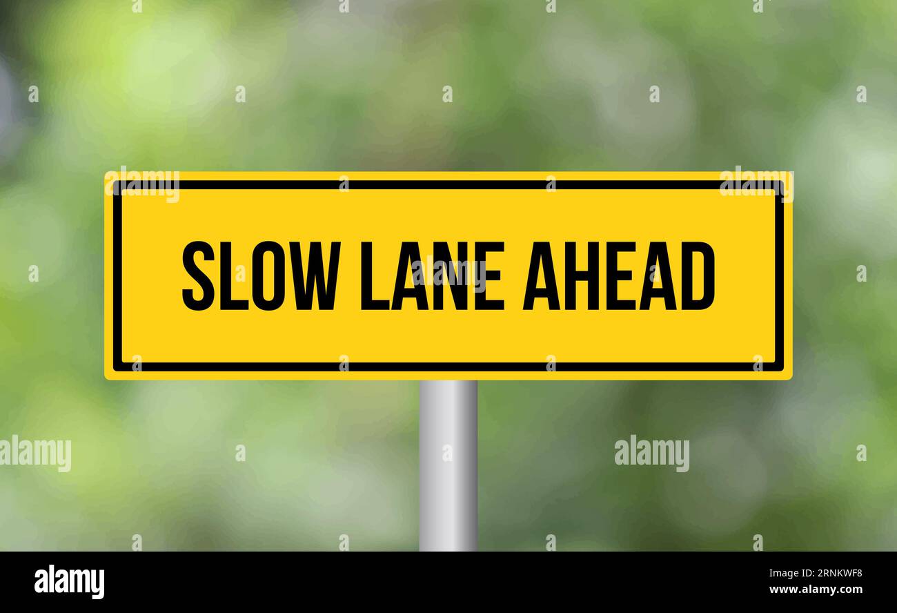 Slow lane ahead road sign on blur background Stock Photo - Alamy