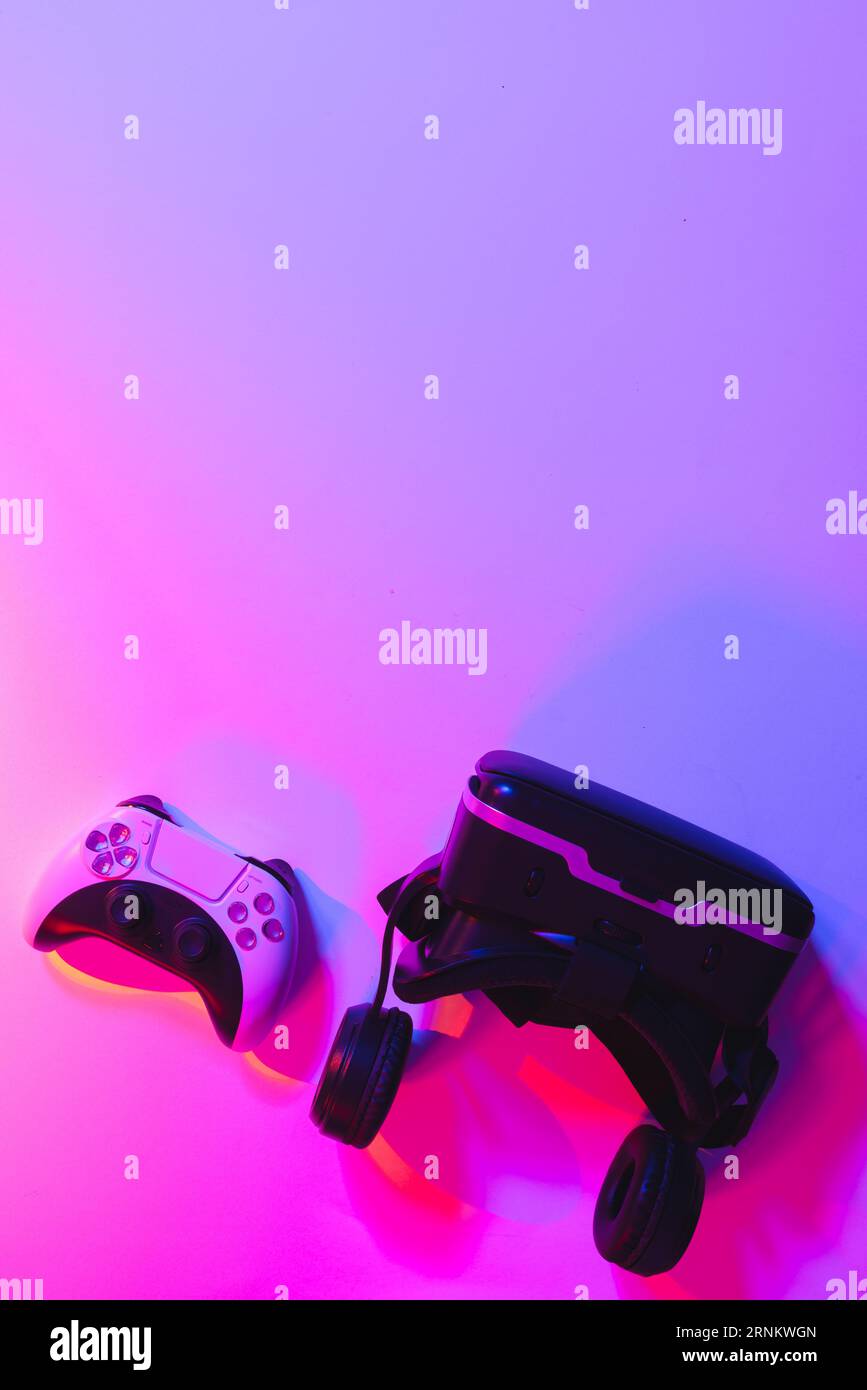 Vertical image of composite of video game pad and vr headset with copy ...