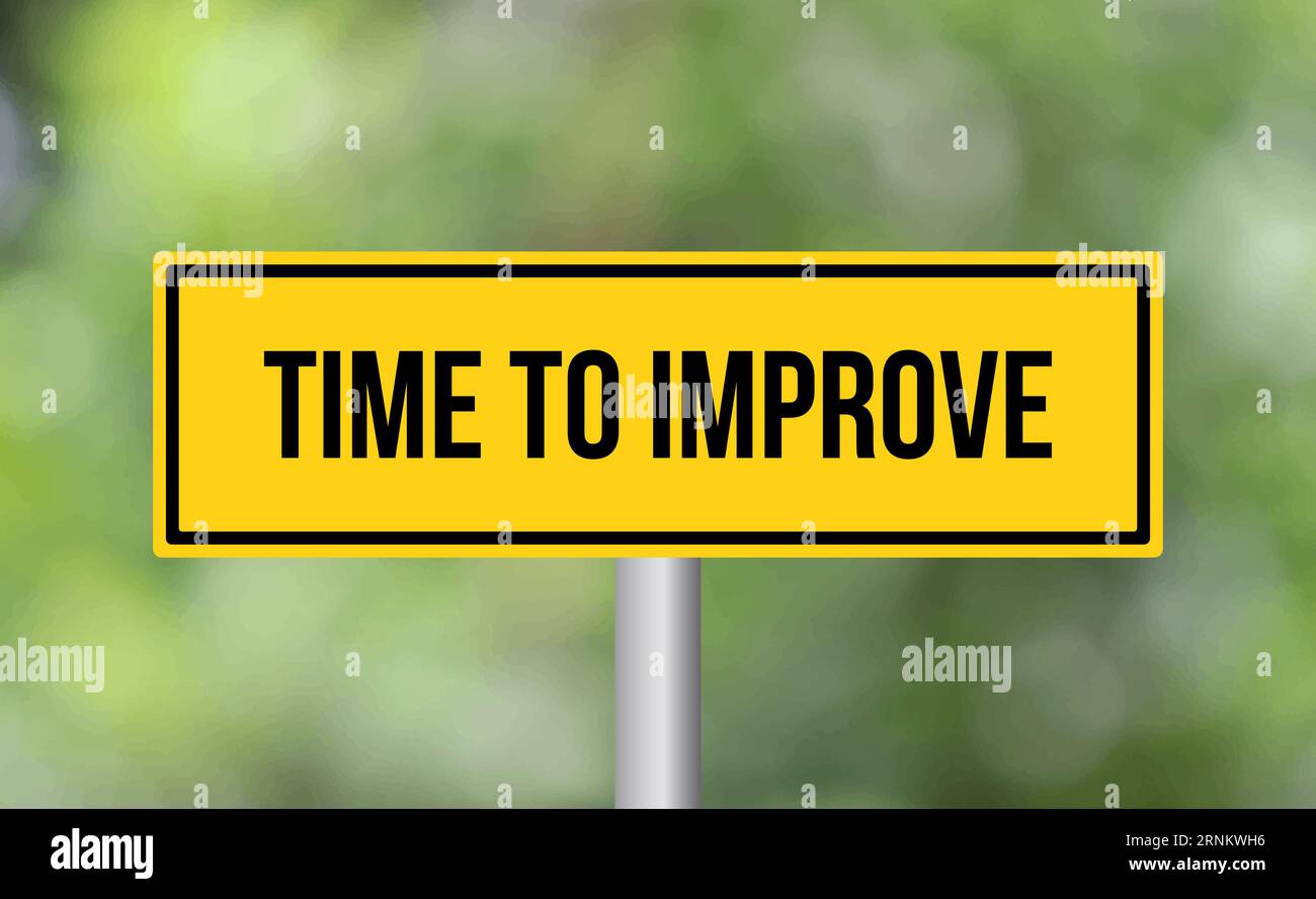 Time to improve road sign on blur background Stock Photo - Alamy