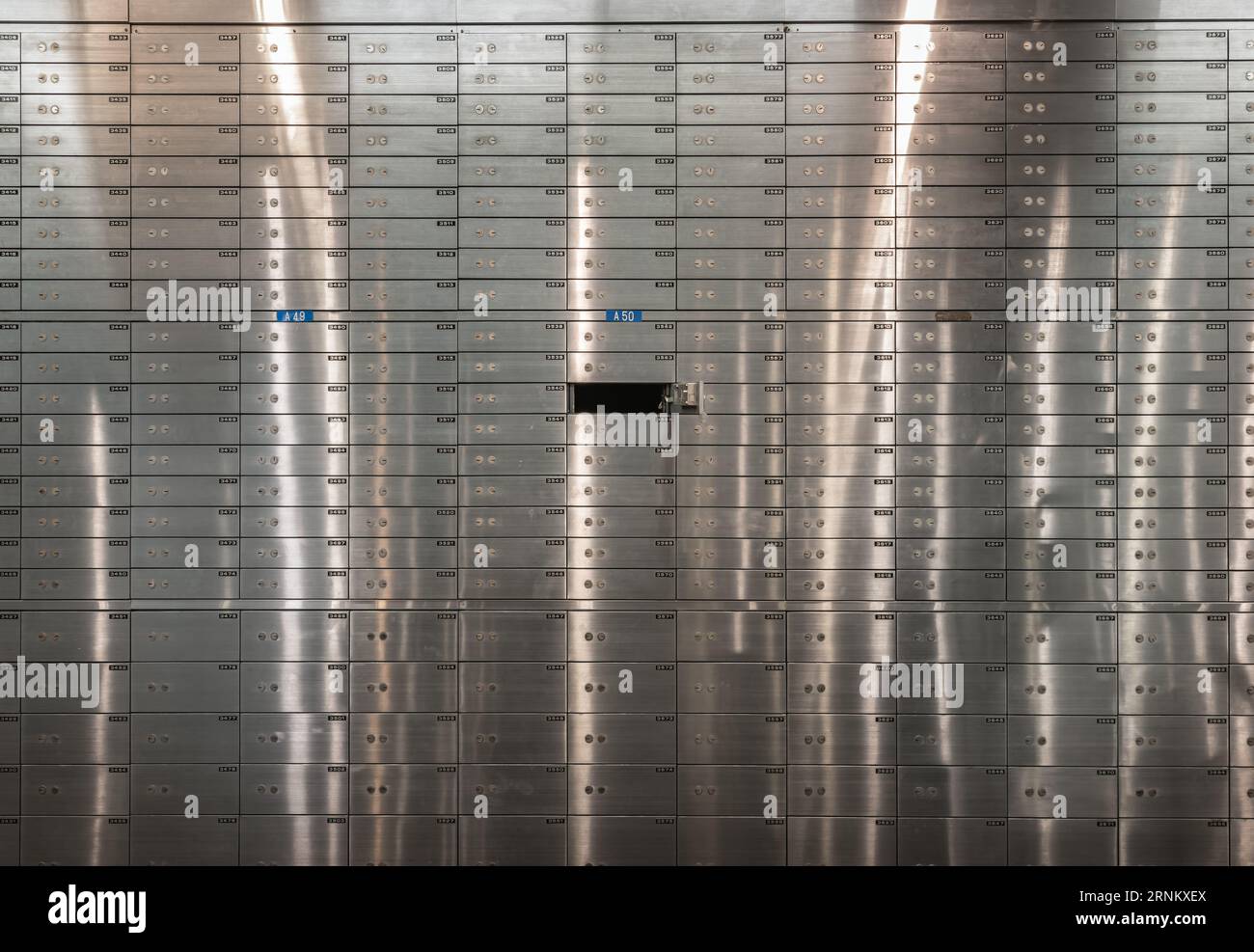Safe deposit boxes inside bank vault with closed steel doors. Metal ...