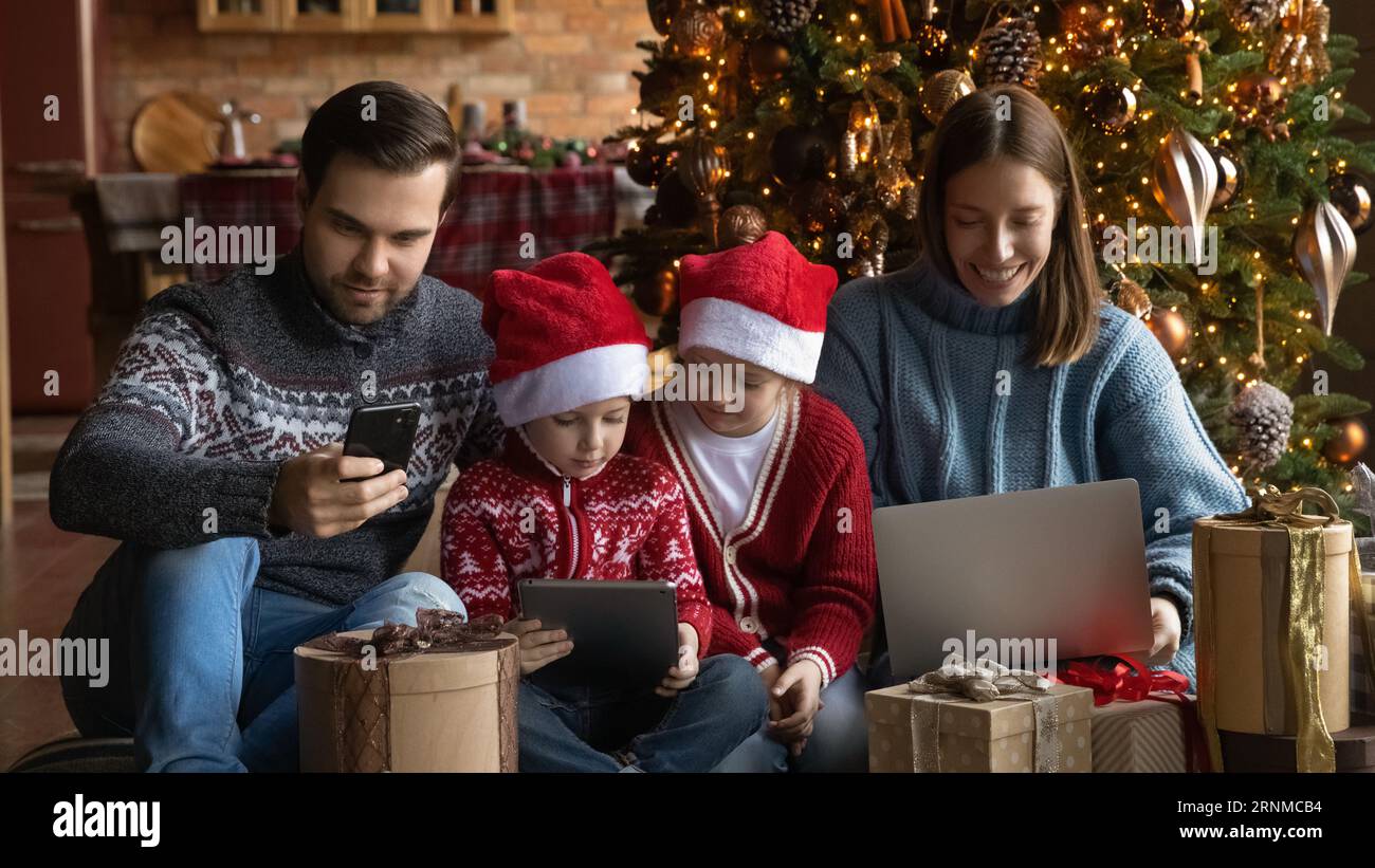 Addicted to modern technology happy family using different gadgets ...