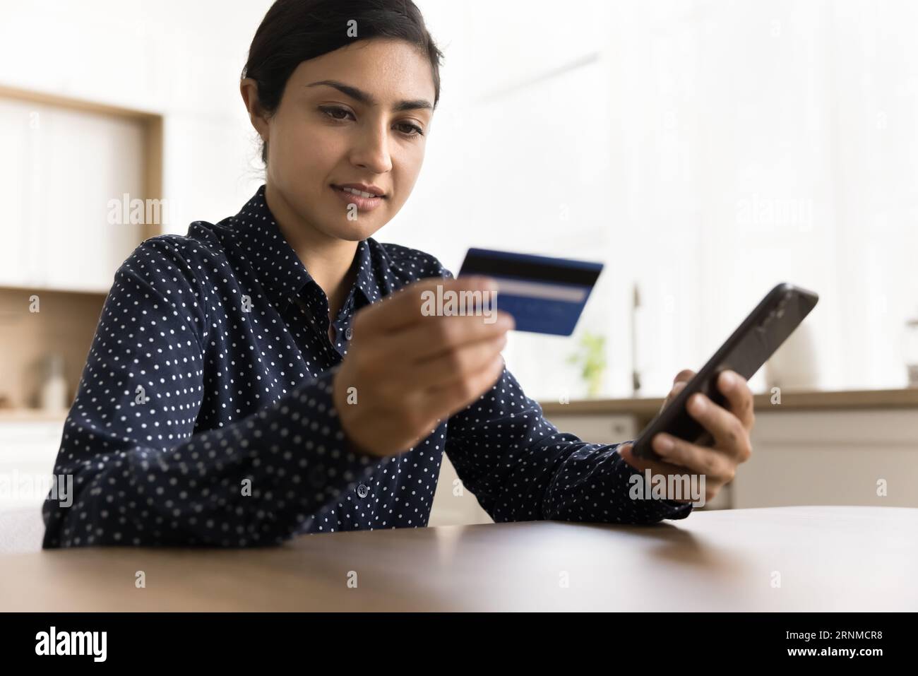 Positive Indian bank customer woman using Internet bank application ...