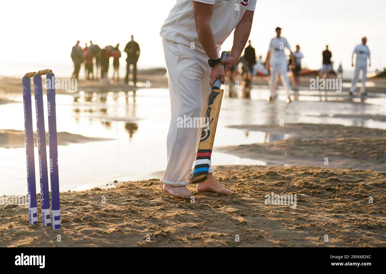 A batter prepares to face a ball as members of the Royal Southern Yacht ...