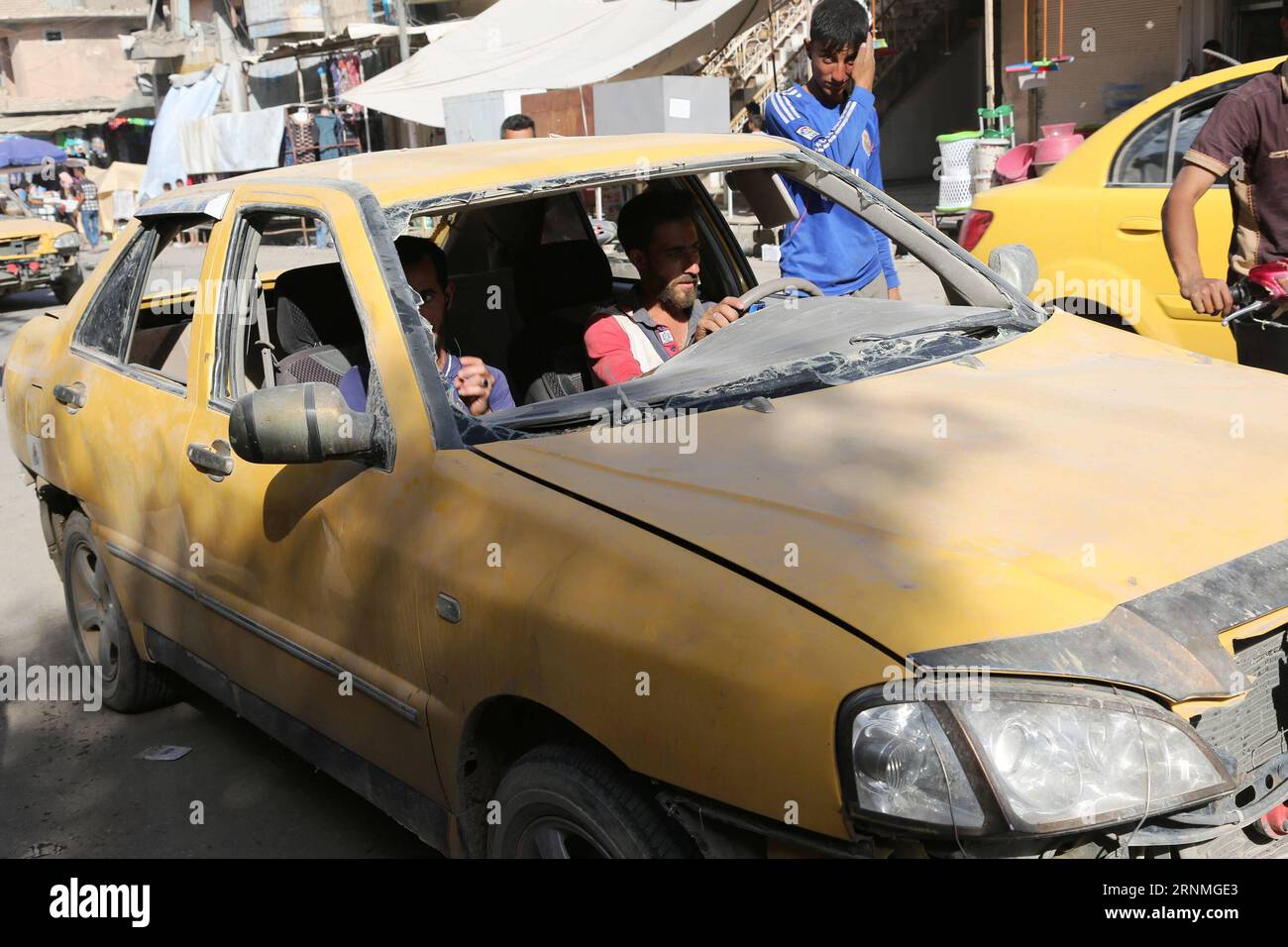(170528) -- MOSUL, May 28, 2017 -- Two men sit in a car without ...