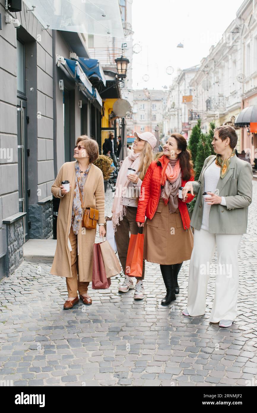 Older women, best friends have fun walking the streets of the city ...