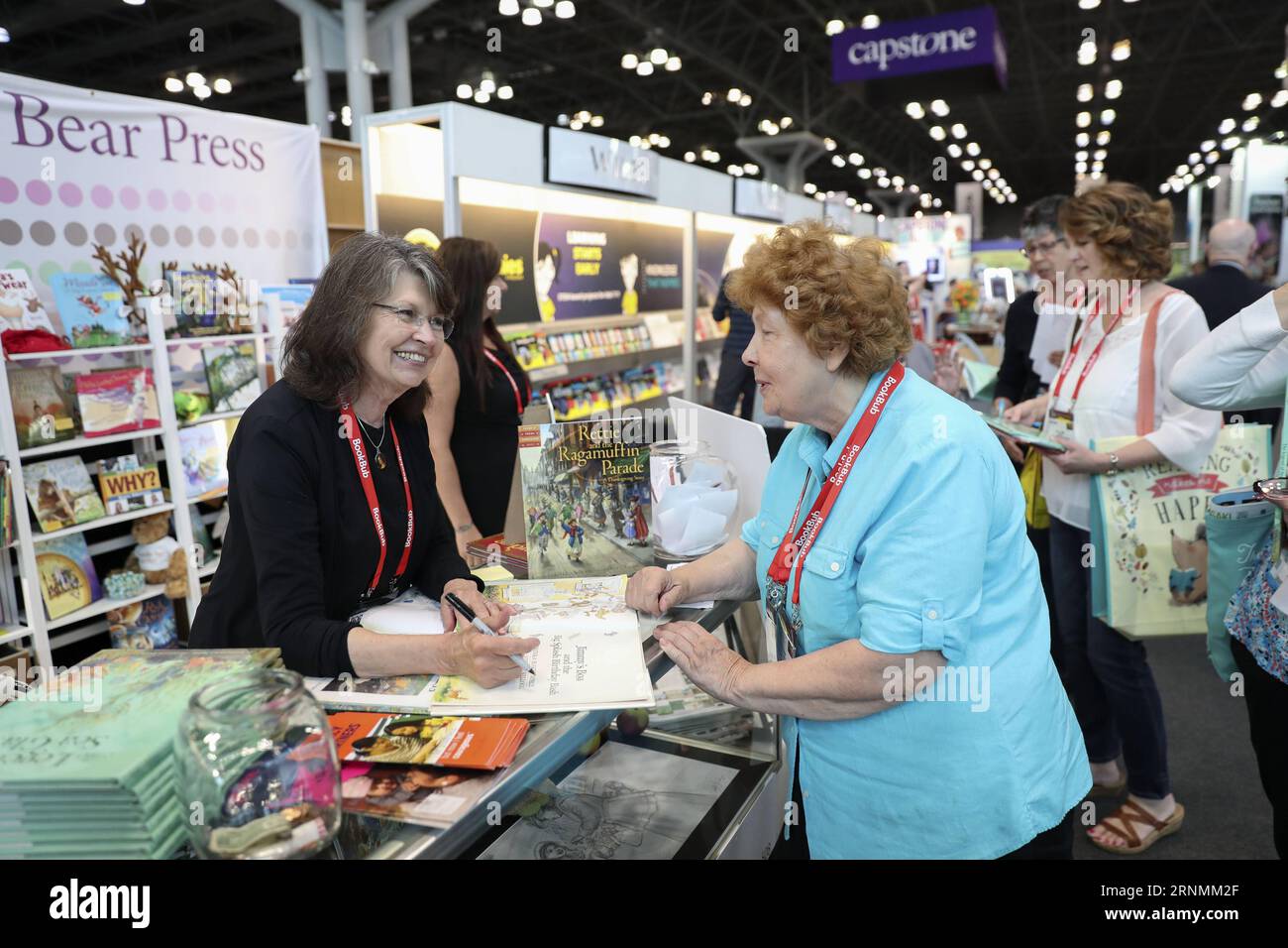 (170602) -- NEW YORK, June 2, 2017 -- Trinka Hakes Noble (L), signs her ...