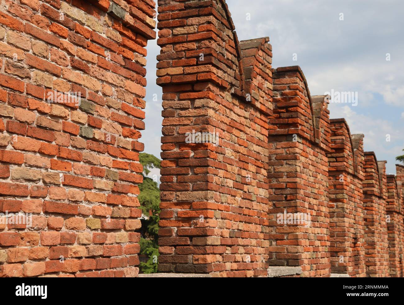 Ancient Battlements with crenellations on the city wall made with red ...