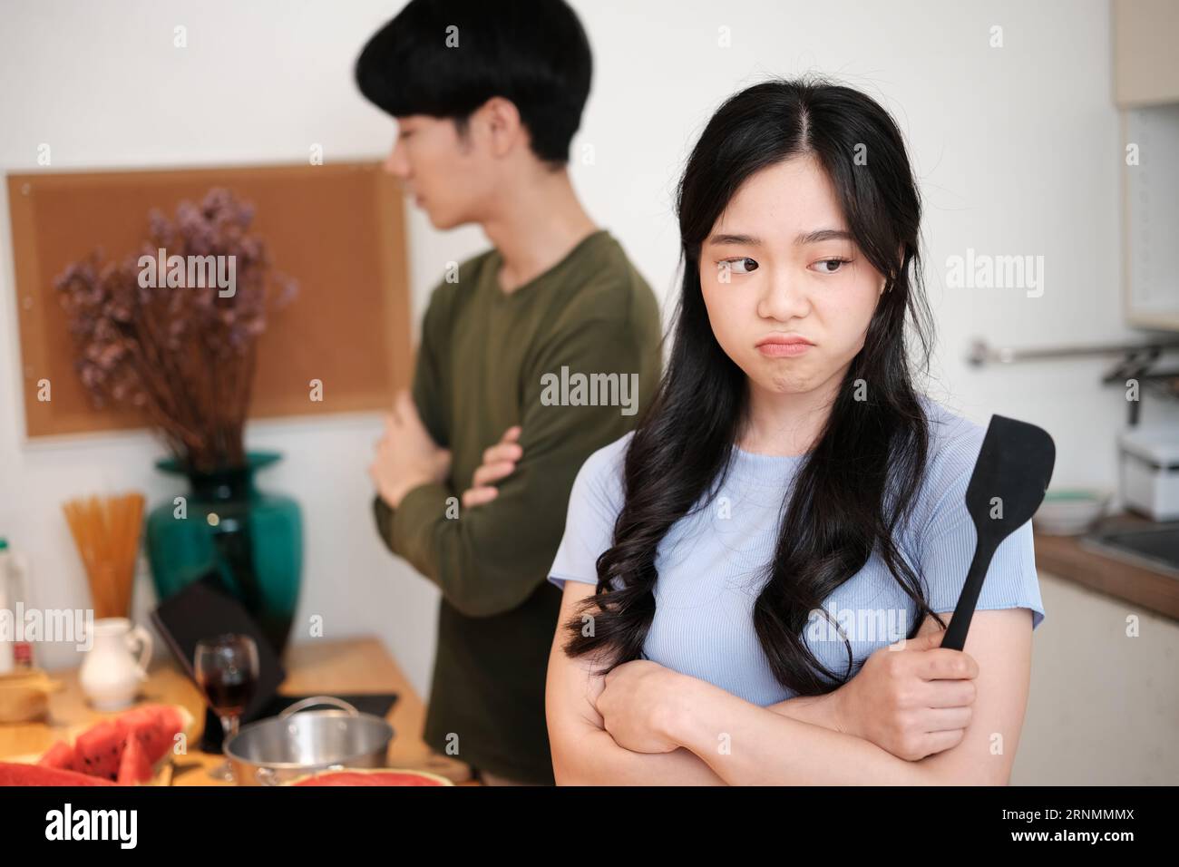 Offended young woman ignoring her upset husband after quarrel in ...