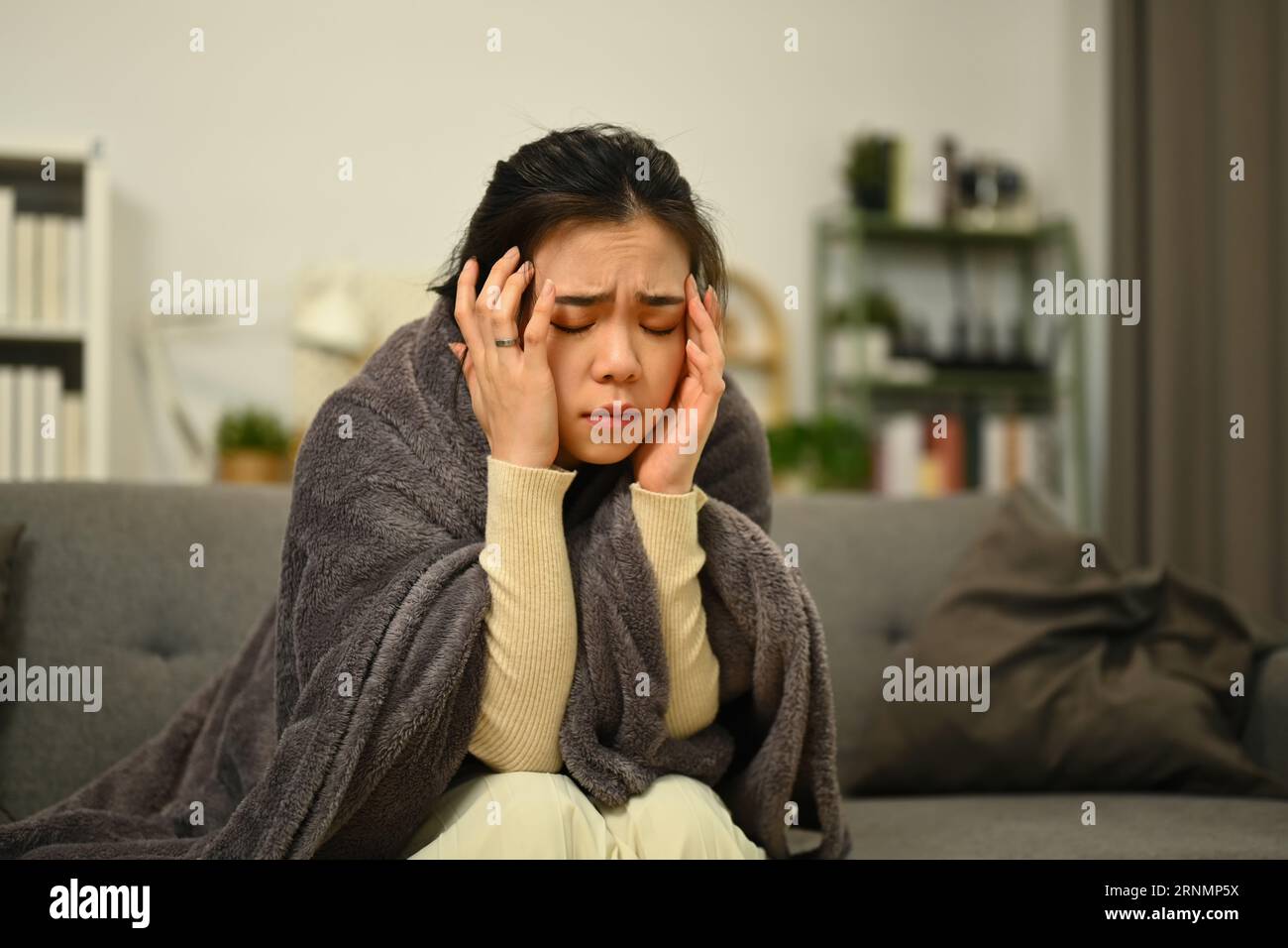 Ill upset young woman asian woman with with high fever and a flu ...