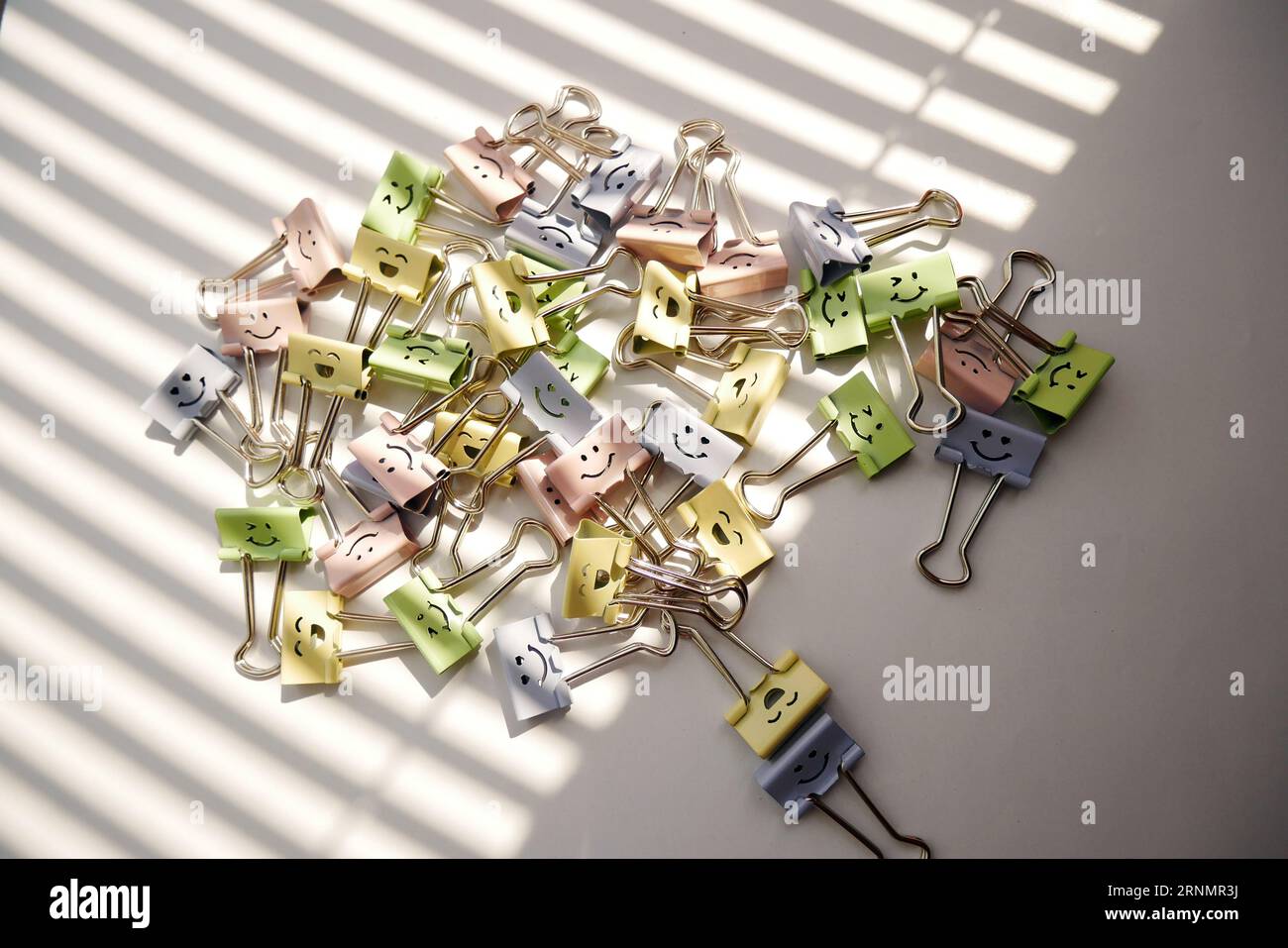 Pastel colored Office Paper Clips, Smiley Binder Clips, and Pencils on ...