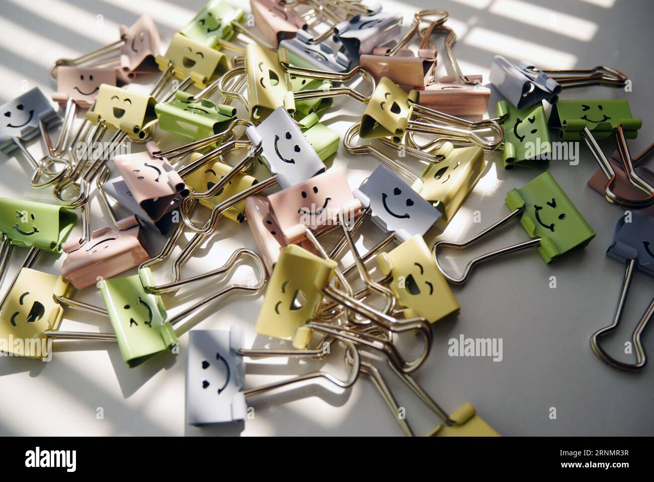 Pastel colored Office Paper Clips, Smiley Binder Clips, and Pencils on ...