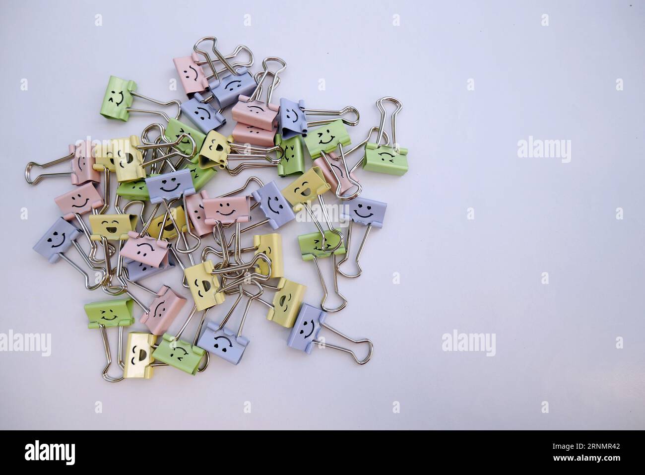 Pastel colored Office Paper Clips, Smiley Binder Clips, and Pencils on ...