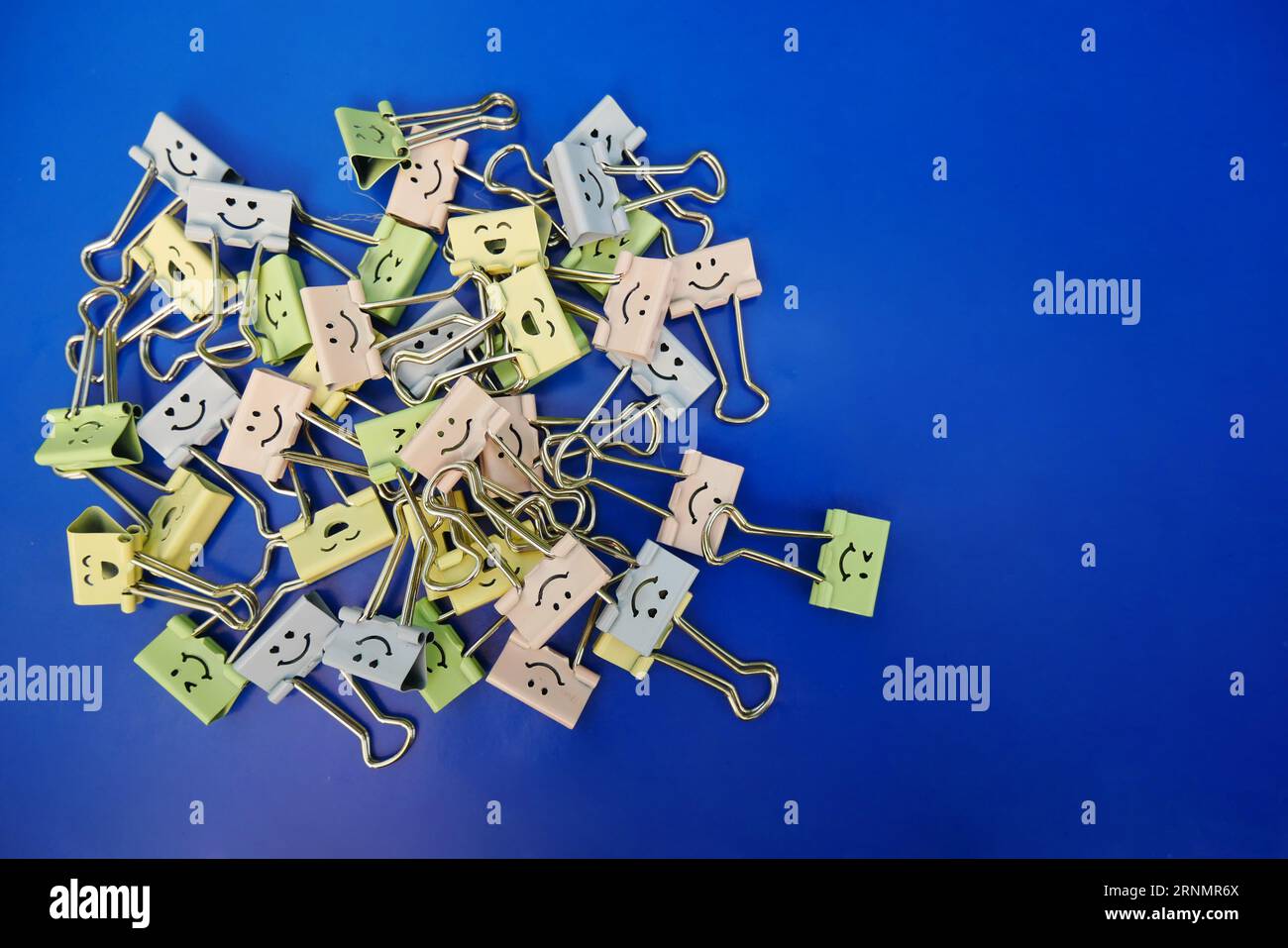 Pastel colored Office Paper Clips, Smiley Binder Clips, and Pencils on ...