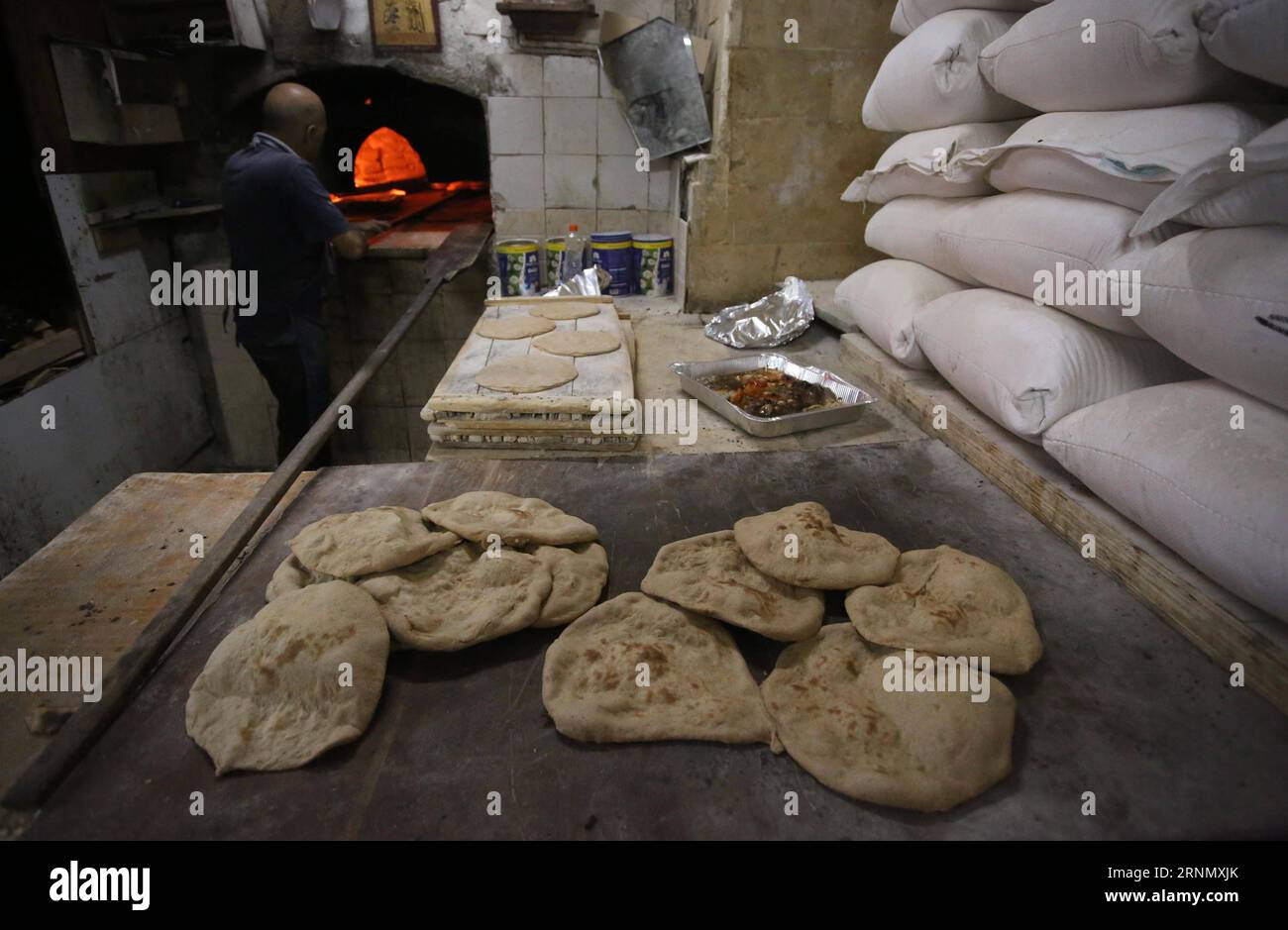 (170614) -- NABLUS, June 14, 2017 -- A Palestinian baker works in his ...