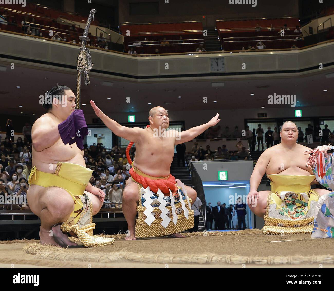 Japan Sumo Association head Hakkaku (C) performs a ring-entering ...