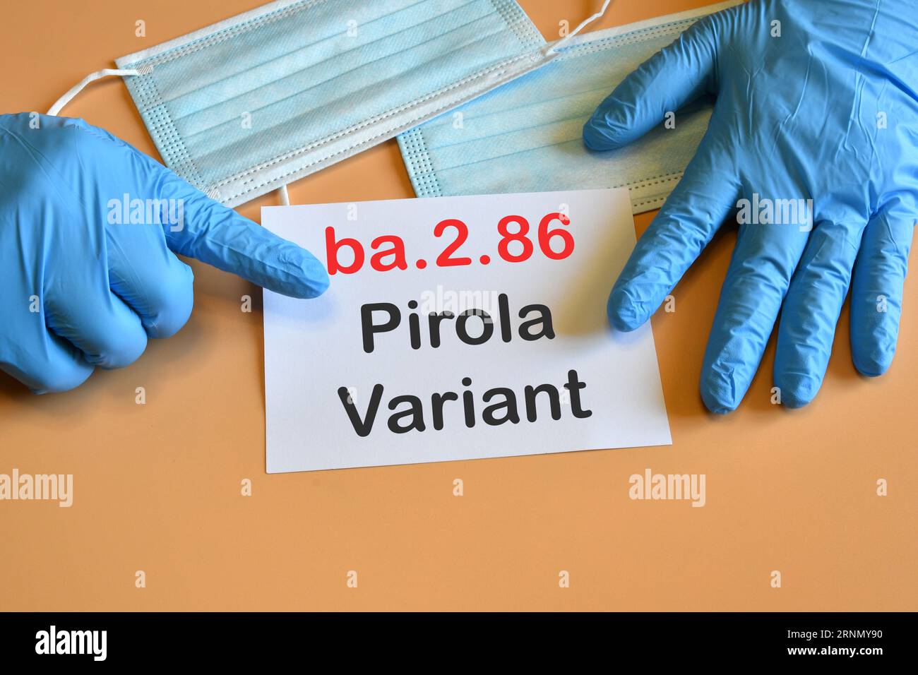 Doctor's hand indicate white sheet with text " ba.2.86 Pirola Variant ...