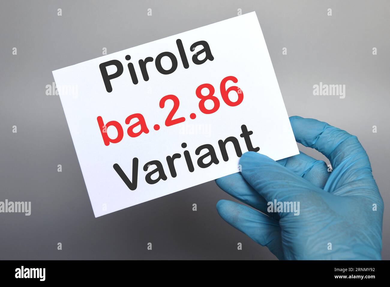 The hands of doctor in blue gloves with white paper and text "ba.2.86 ...