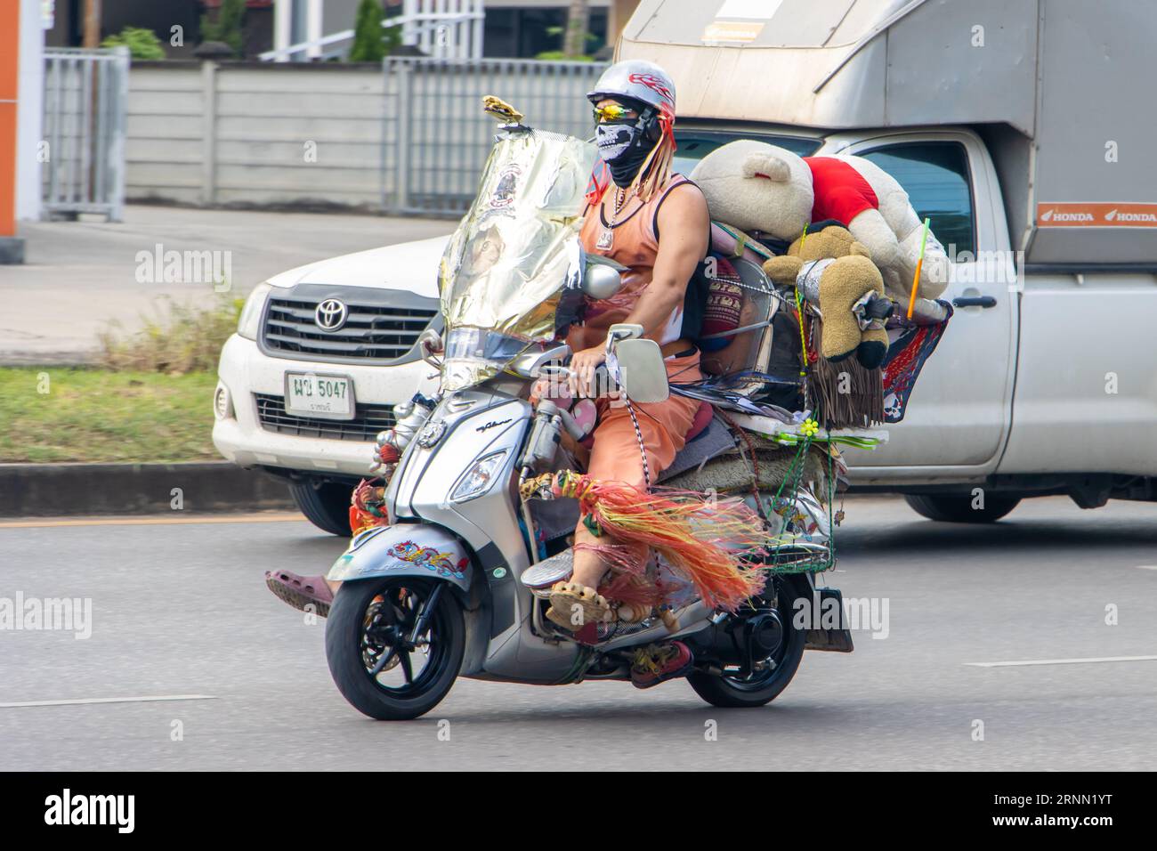 RATCHABURI, THAILAND, OCT 18 2022, a man rides a motorcycle loaded with ...