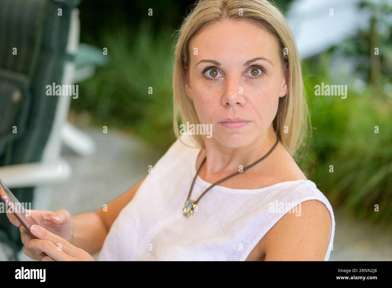 Young attractive woman in her forties looking at the camera with a ...
