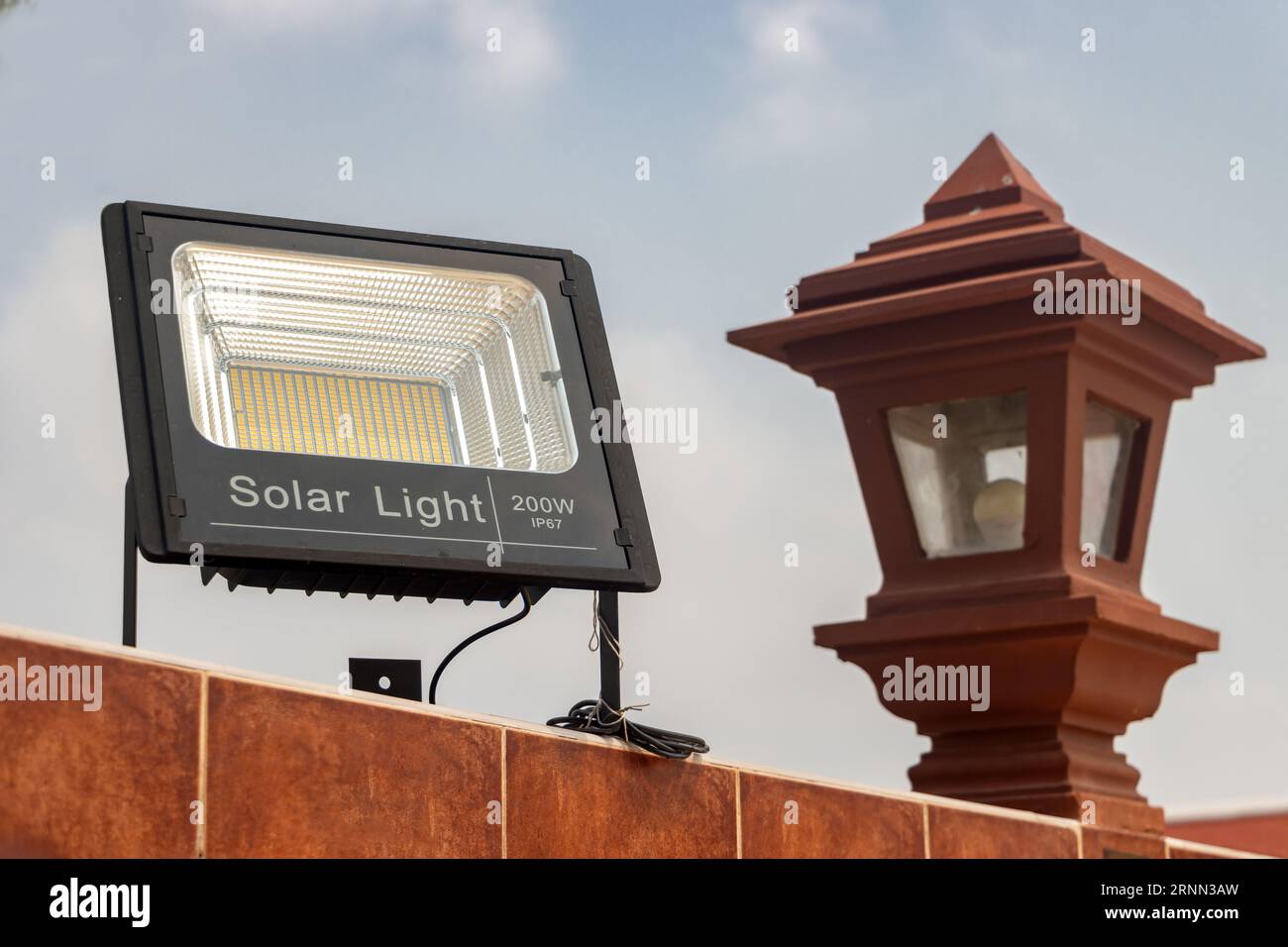 Reflector powered by solar panels fixed on the wall Stock Photo - Alamy